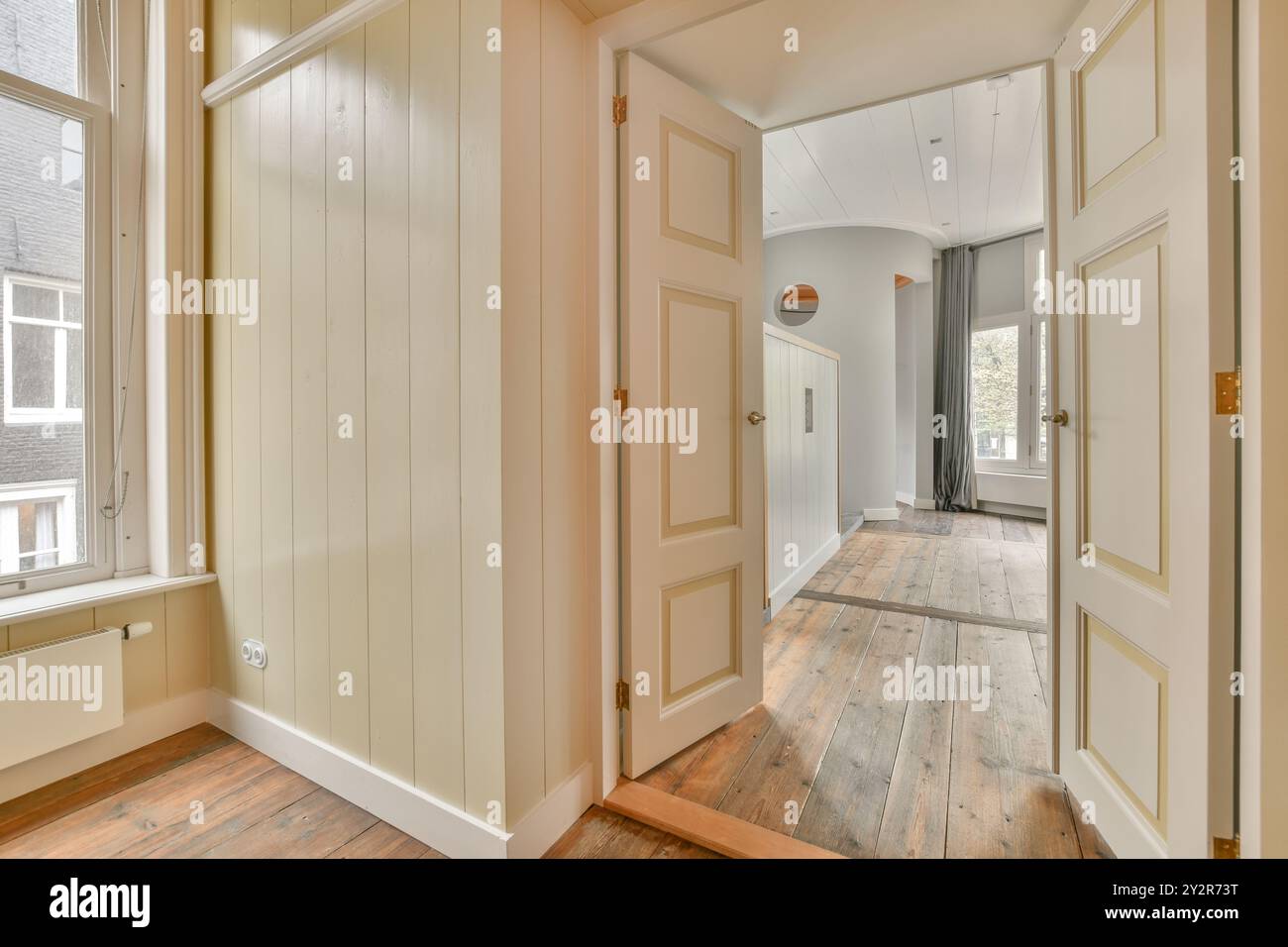 Warm and welcoming empty hallway in a house, featuring wooden floors ...