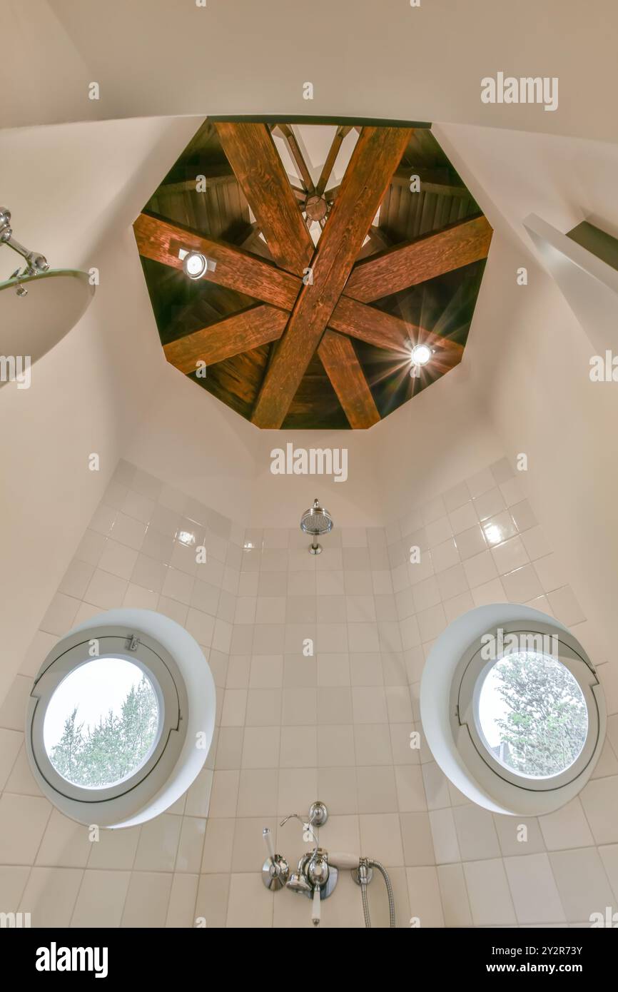 A contemporary bathroom interior features elegant wooden beams, round ...