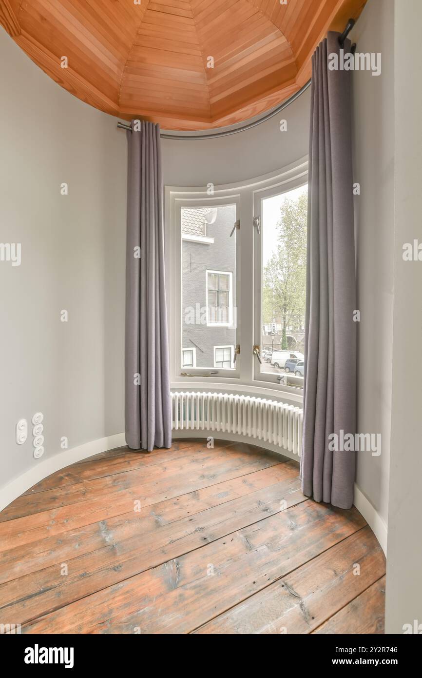 An interior view of a bay window with a unique curved wooden ceiling ...