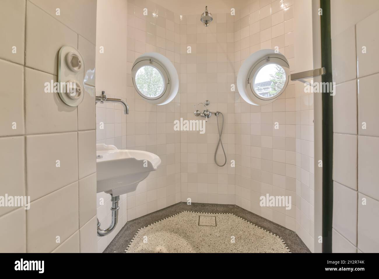 A pristine, well-lit bathroom corner with a shower, featuring two ...