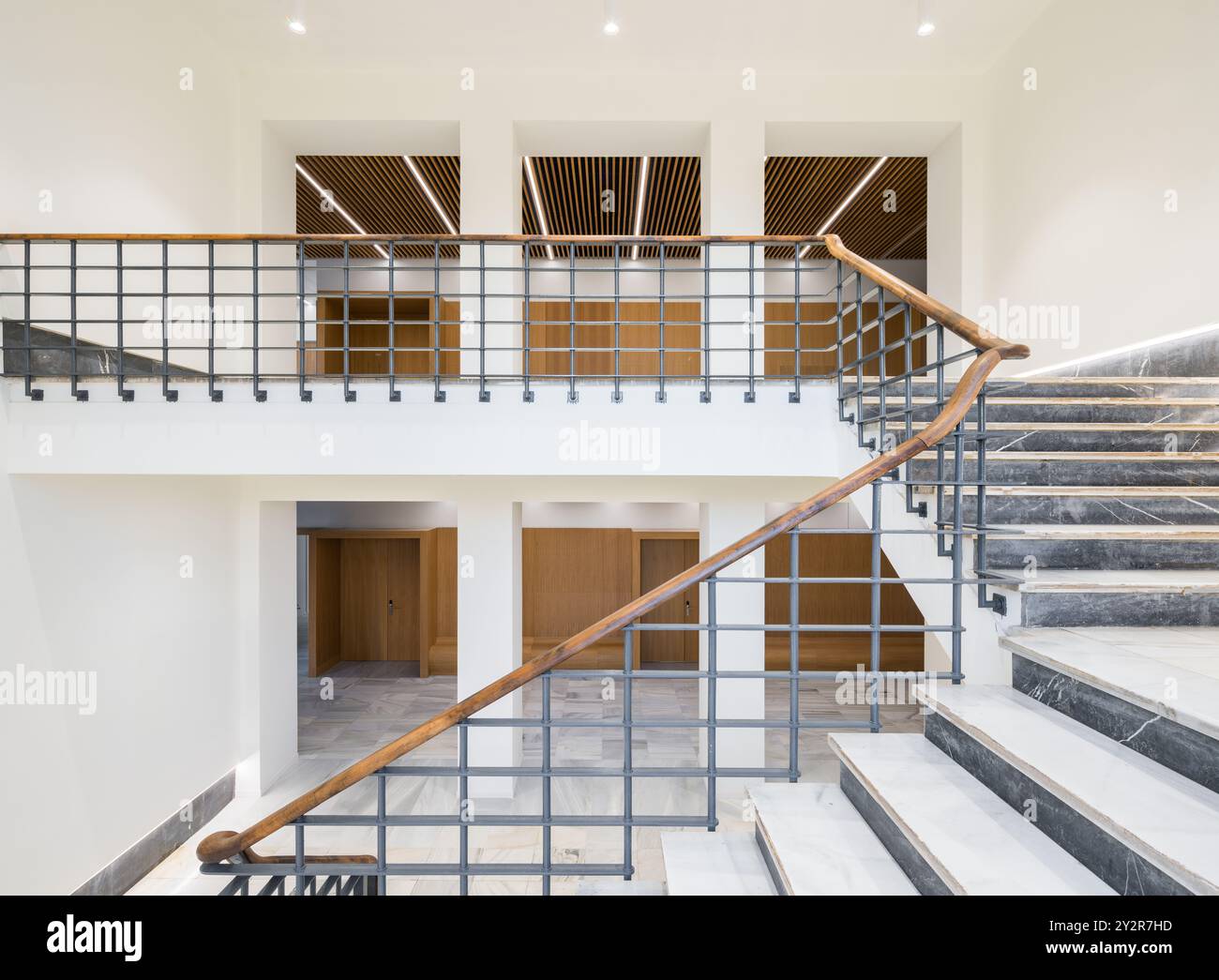 Spacious university lobby with modern staircase, marble floors, and ...