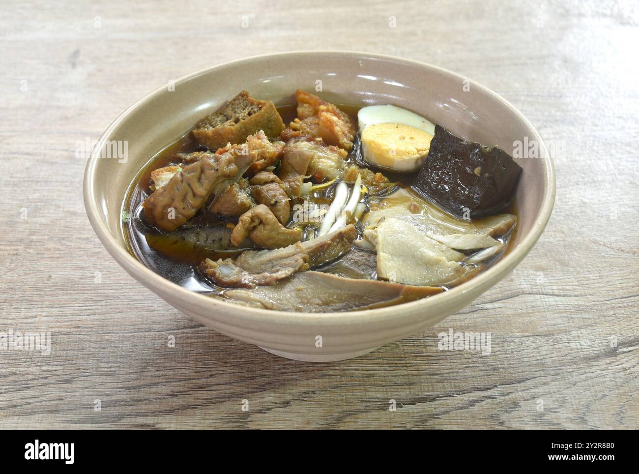 boiled slice pork and entrails topping blood with egg in herb brown ...