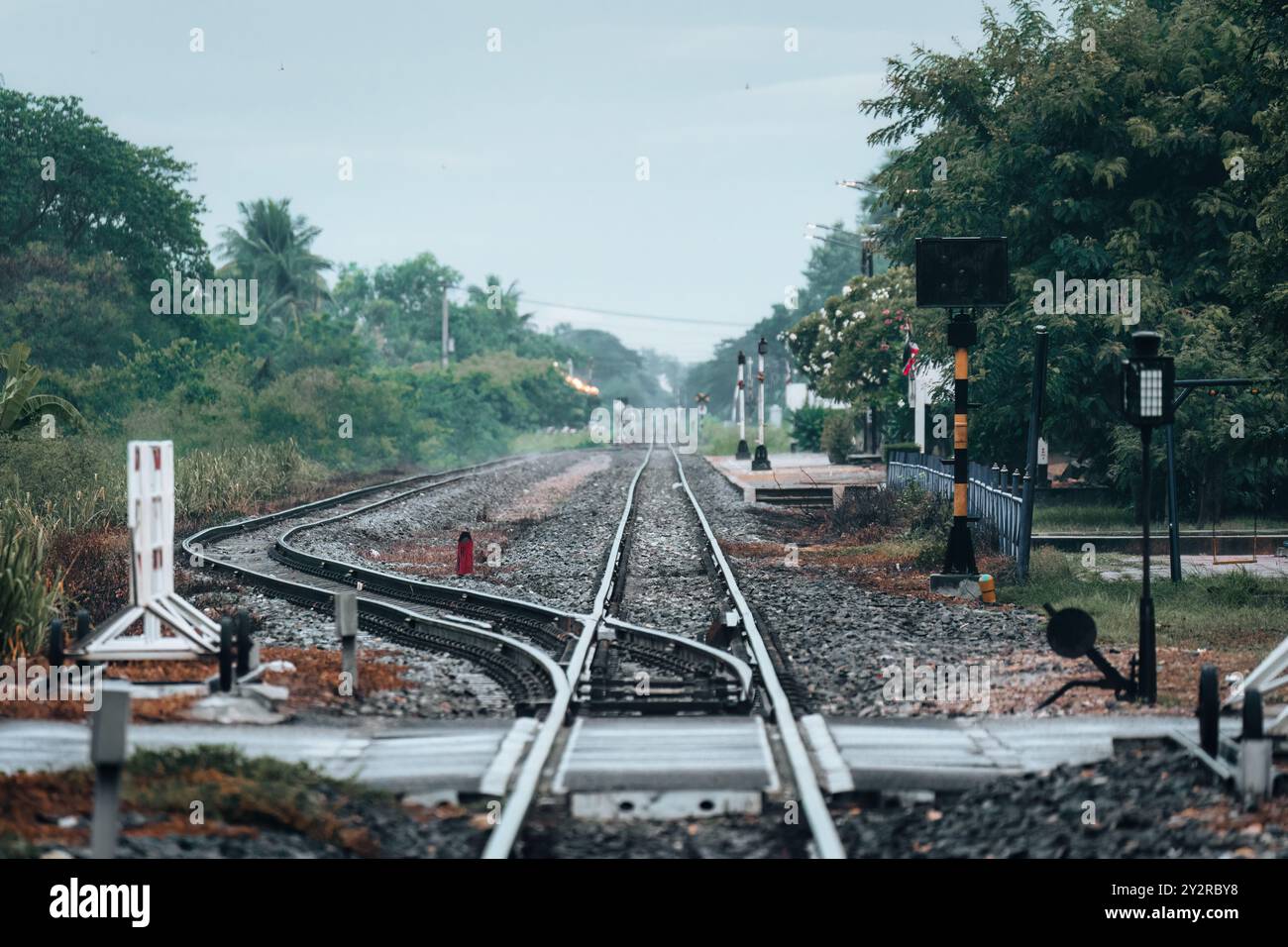 Empty train track, metal railway with rail switching and signboard pole ...