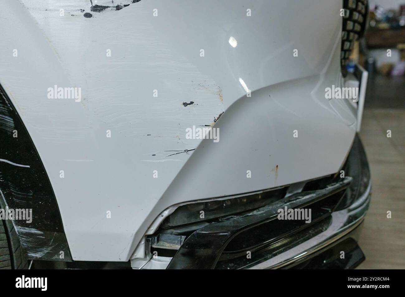 The front of white modern SUV car suffered damage and broken to bumper ...
