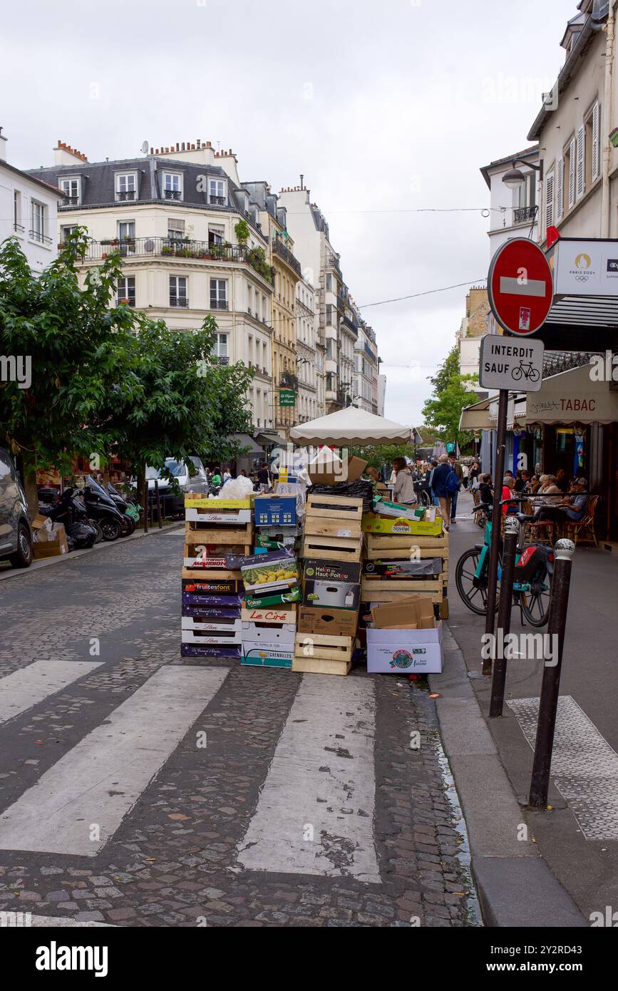 Empty cardboard boxes and crates standing in the road. Fruit packaging ...