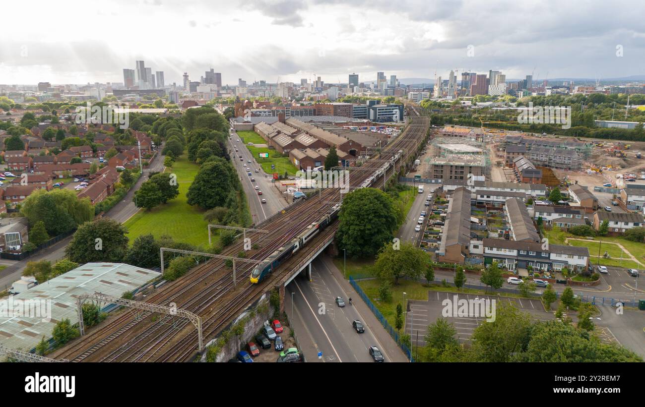 Aerial Manchester railway with Hyde road running into the city skyline ...
