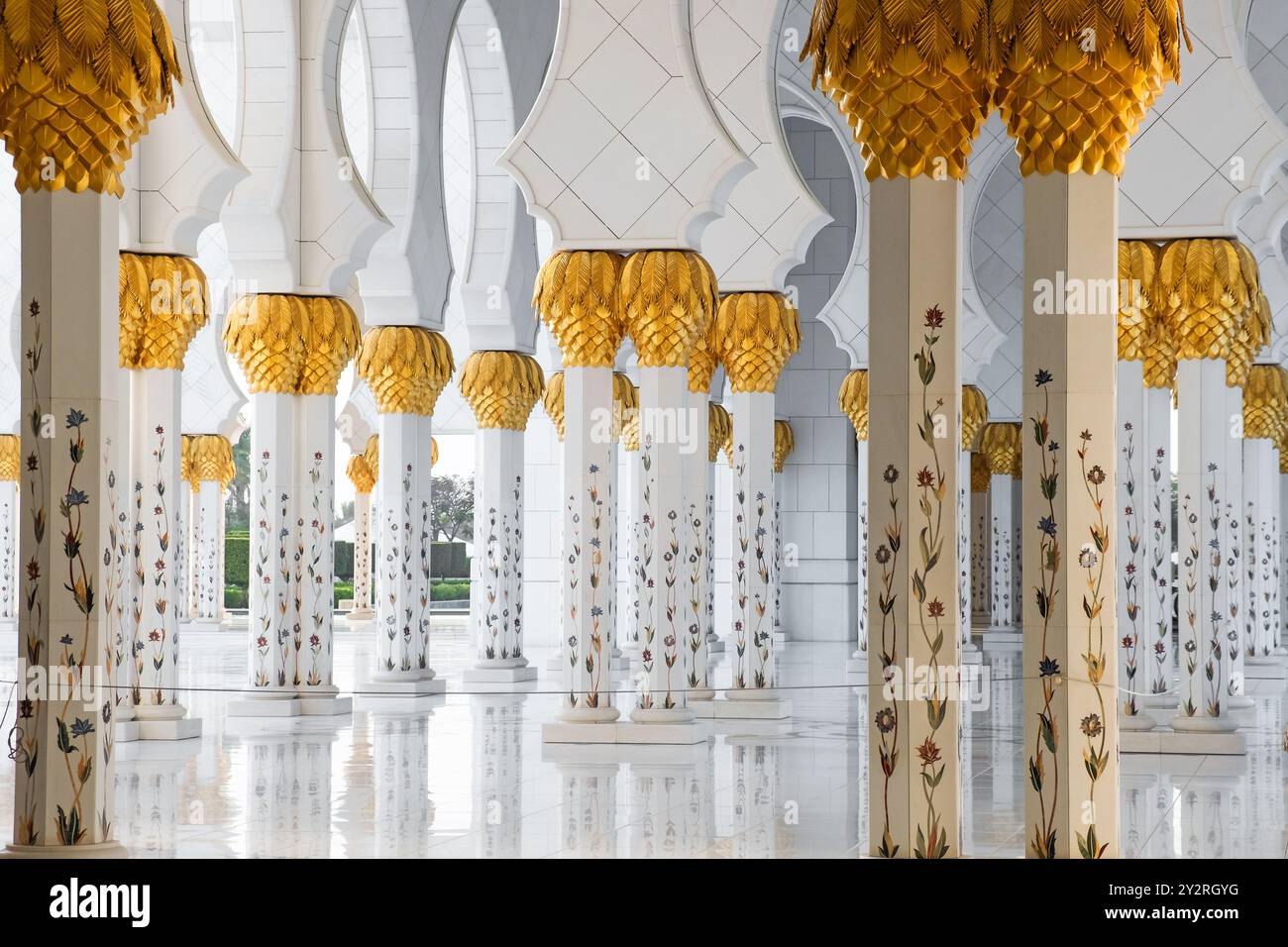Interior of Sheikh Zayed Grand Mosque with ornate columns with golden ...