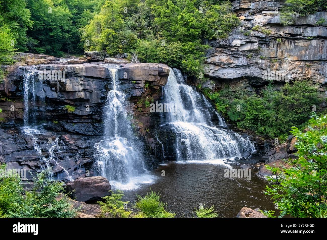 A stunning Blackwater Falls State Park cascading over rocky cliffs ...