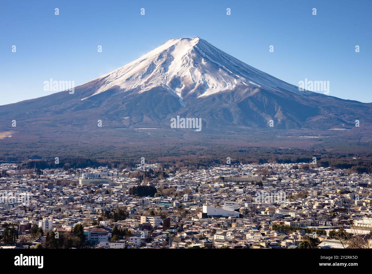 A stunning view of Mount Fuji with snowy peak and a clear blue sky ...
