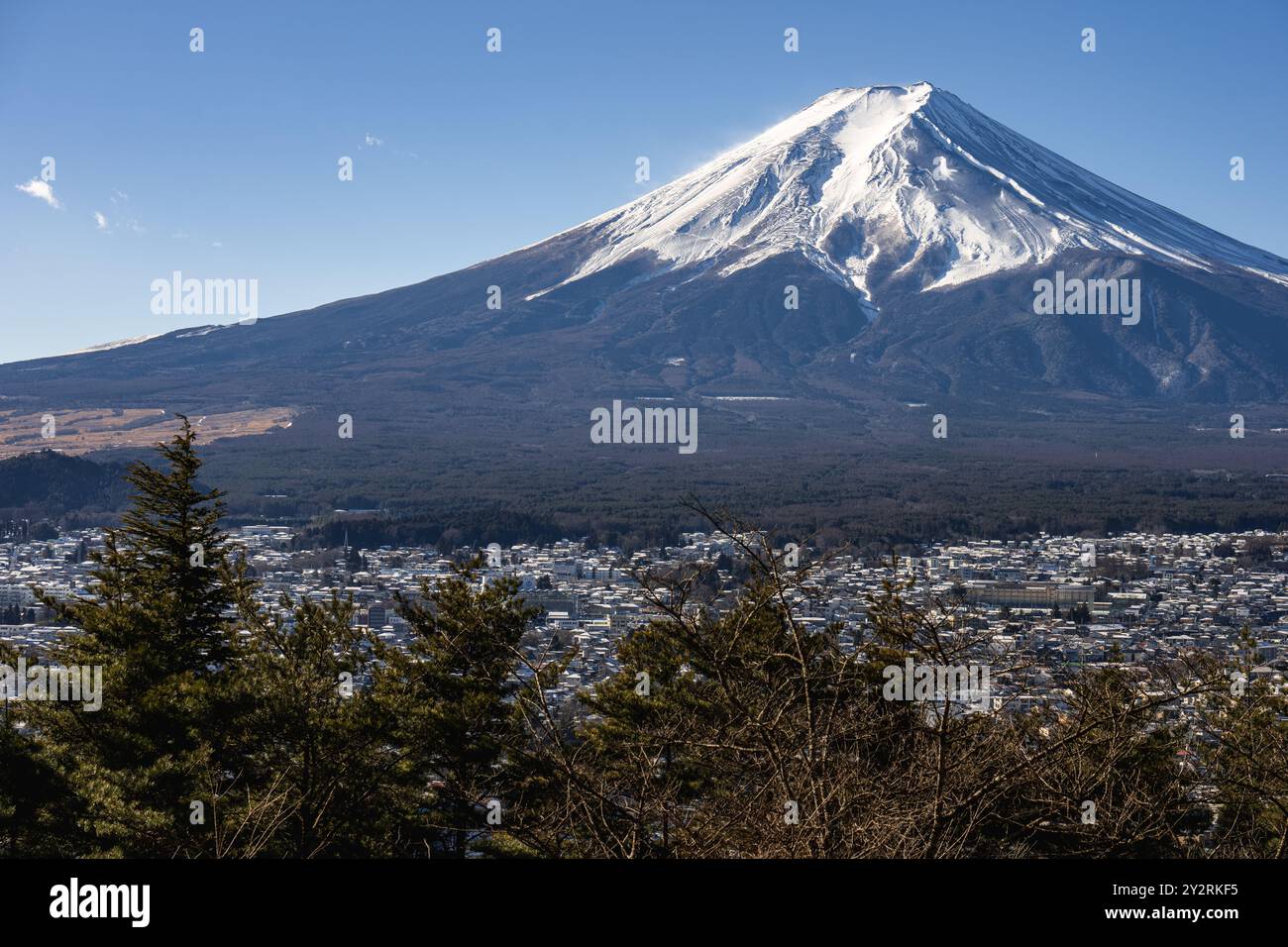 A stunning view of Mount Fuji with snowy peak and a clear blue sky ...