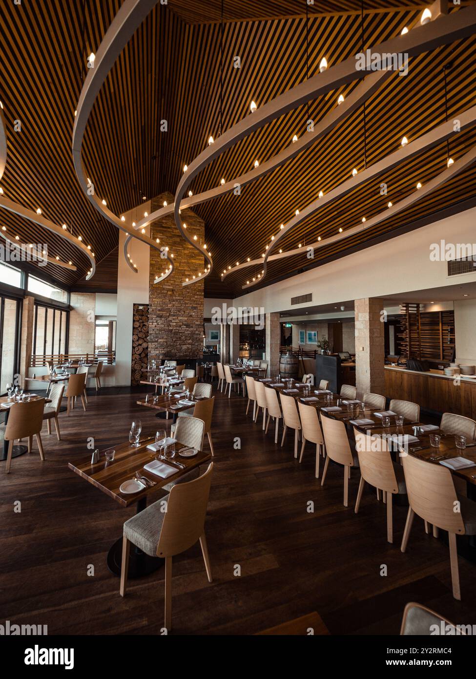Modern restaurant interior with elegant wooden ceiling design and well ...