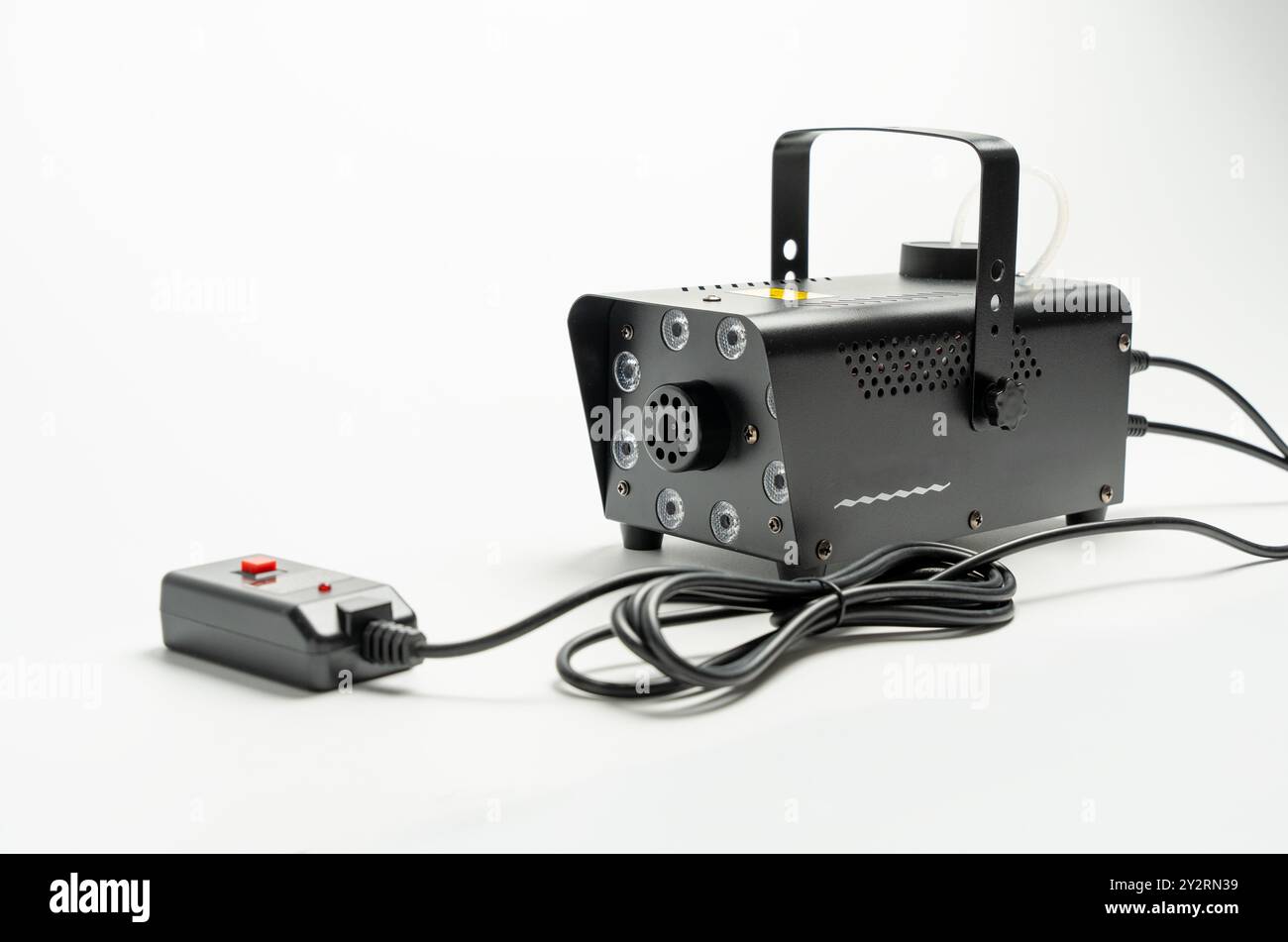 A black device with a cord attached to it. The cord is plugged into a ...