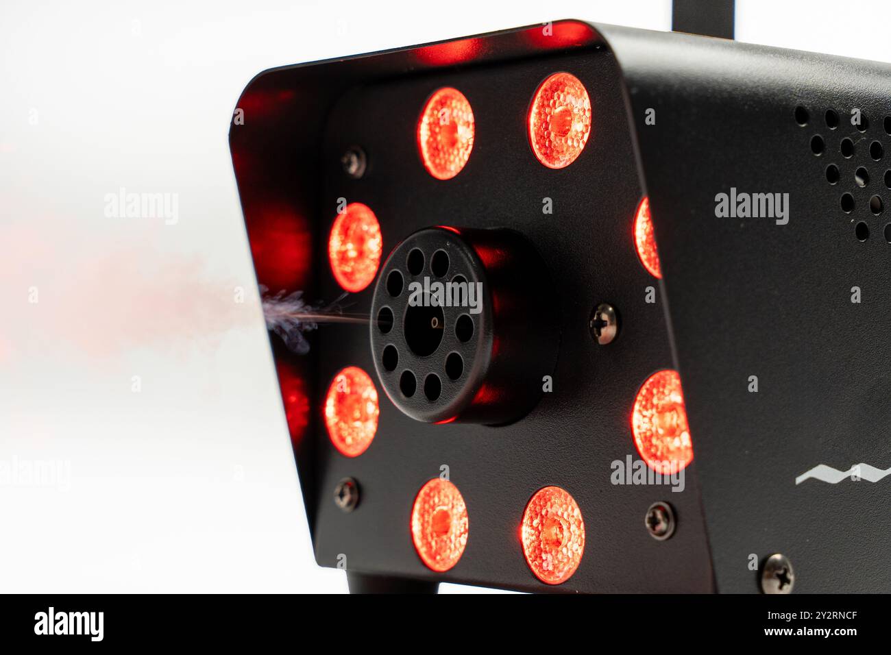 A black device with red lights that emits smoke. The device is ...