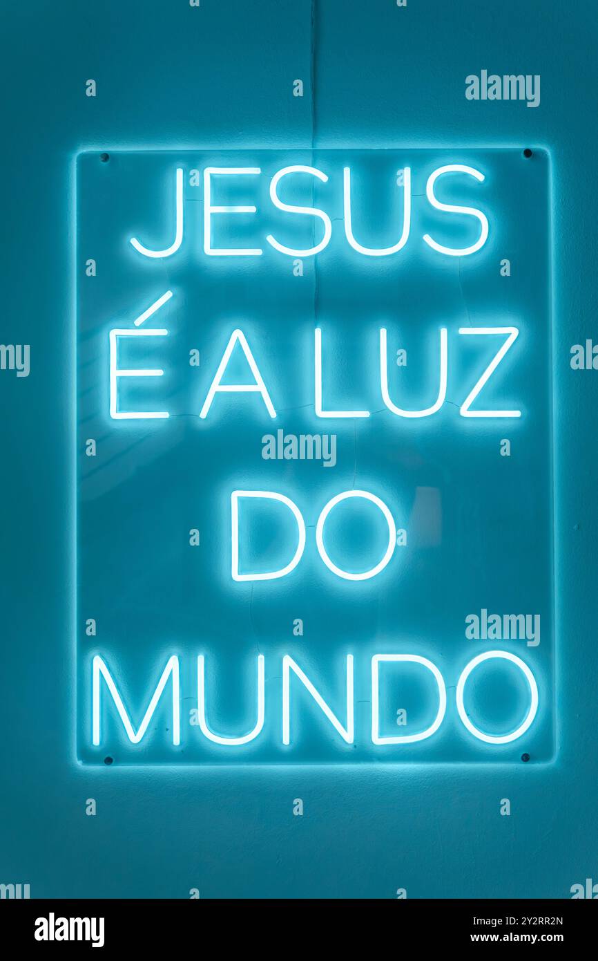 A Neon sign reading Jesus e a luz do mundo against a blue background ...