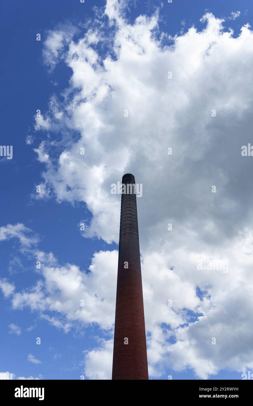 Tall brick smokestack under a cloudy sky Stock Photo - Alamy