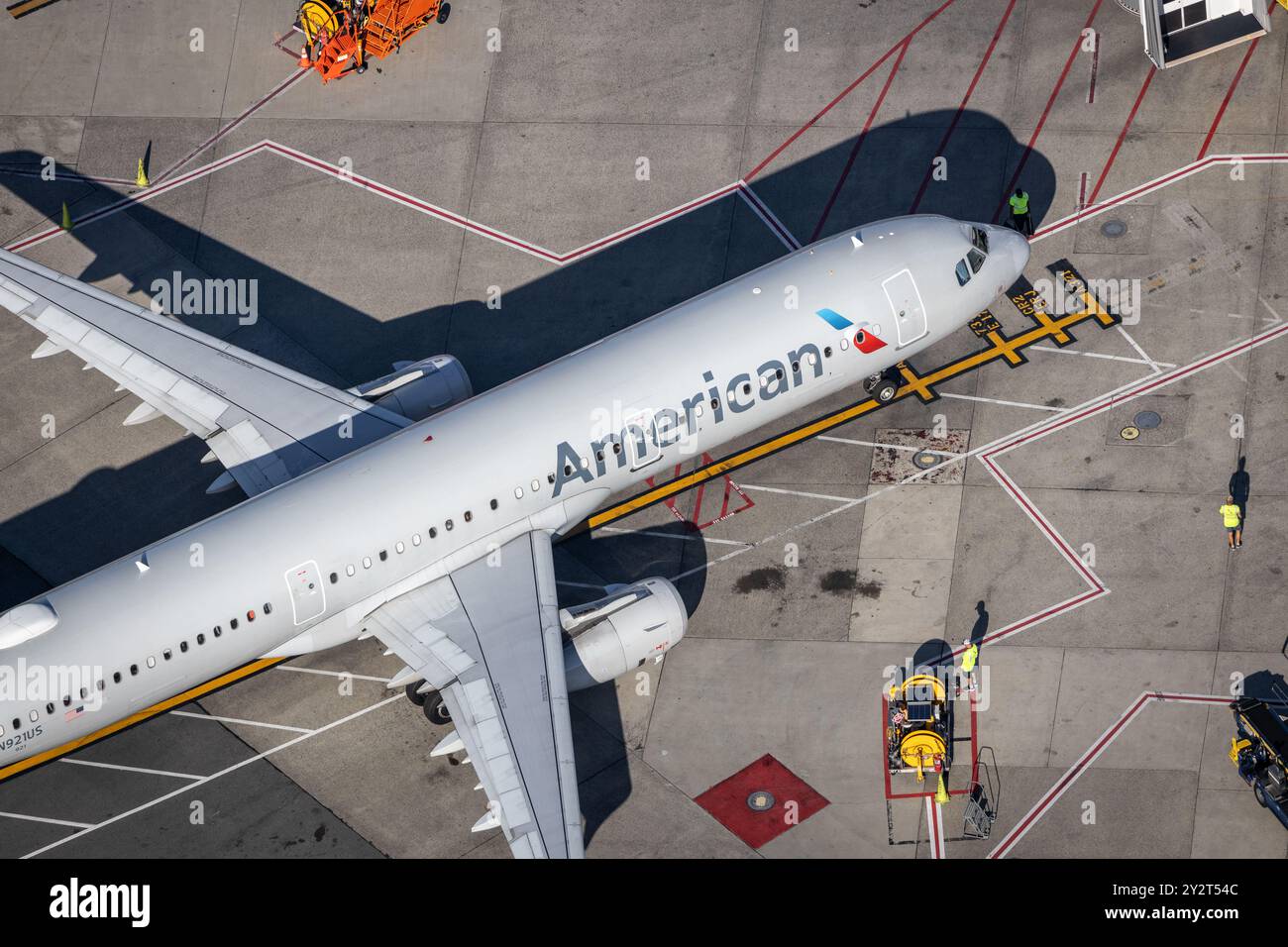 An aerial view of an American Airlines plane parked at an airport gate ...