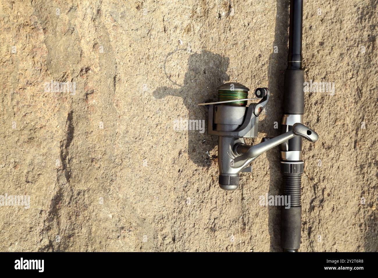 One fishing rod on ground outdoors, top view. Space for text Stock ...