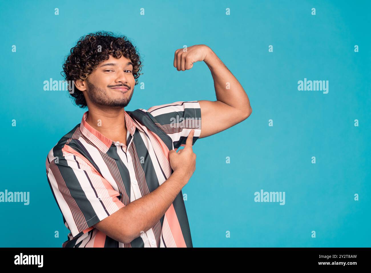 Photo of nice young man point finger biceps empty space wear shirt ...