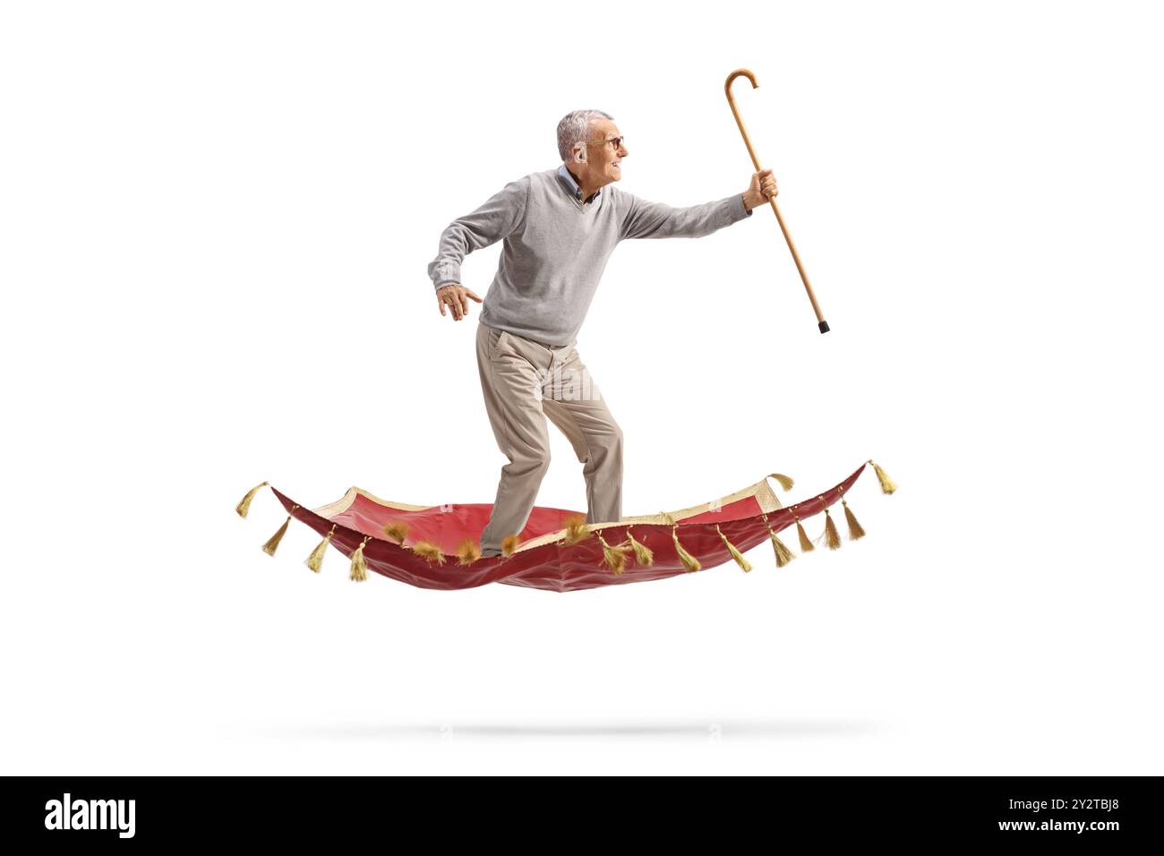 Elderly man flying with a magic carpet isolated on white background ...