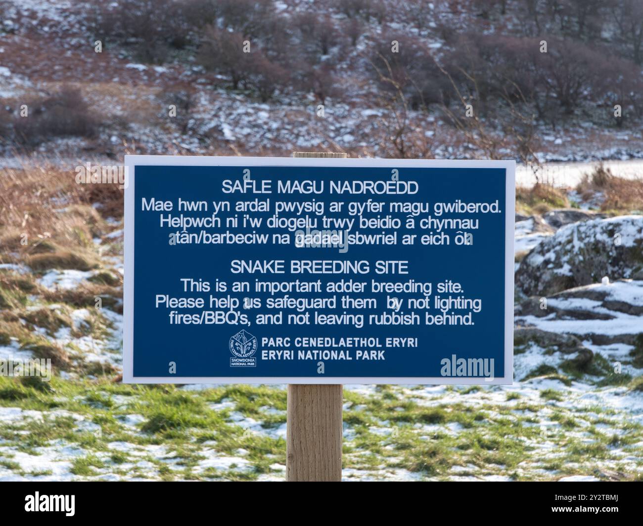 Snake breeding area warning sign in a natural wildlife area partially ...