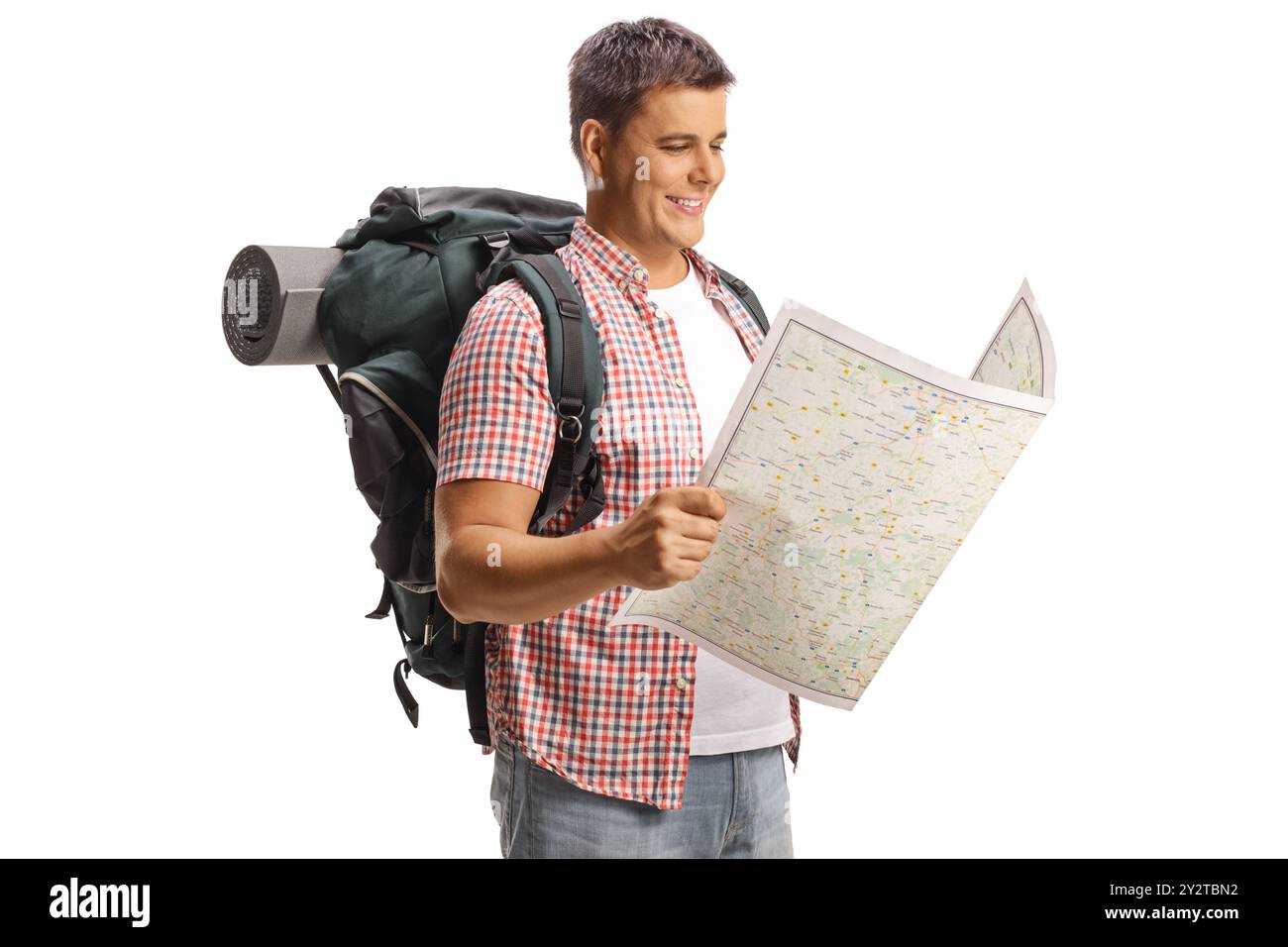 Young man with a backpack reading a tourist map isolated on white ...