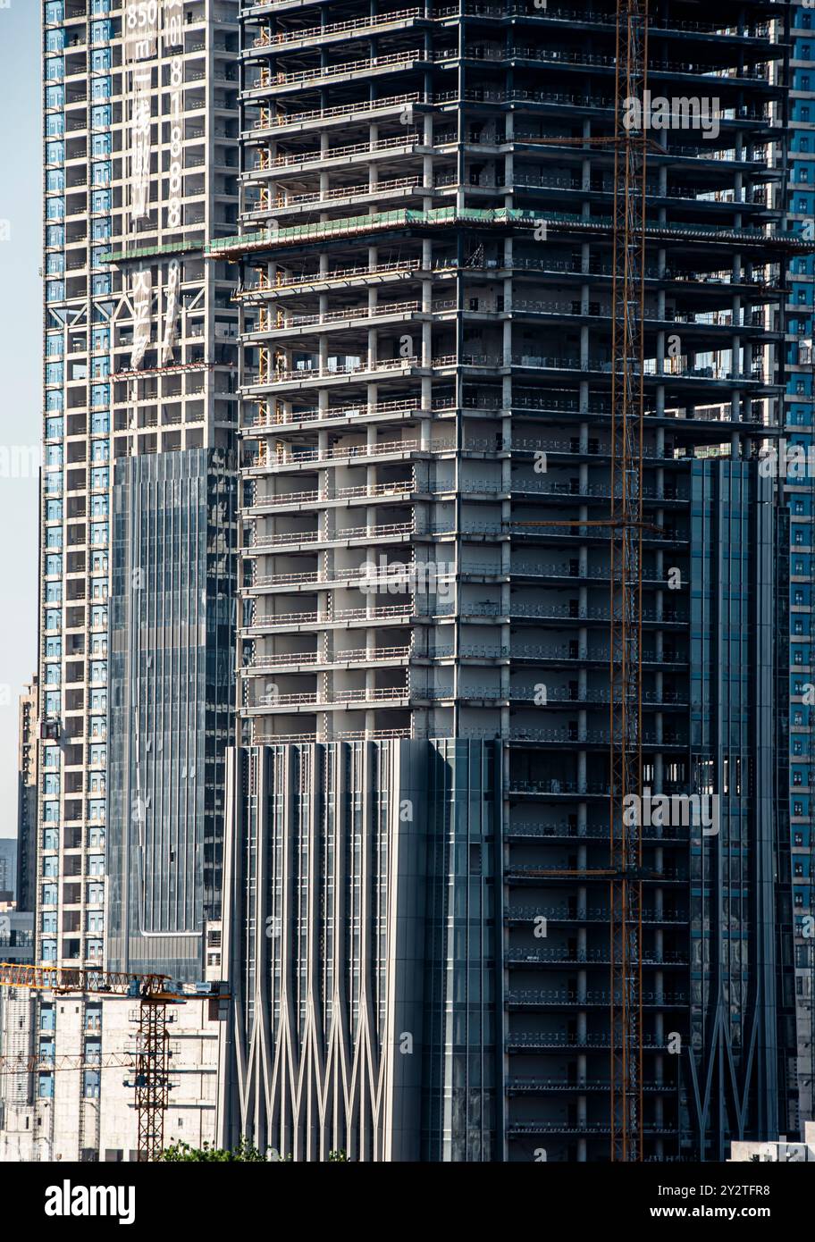 A close-up view of a modern high-rise building under construction with ...