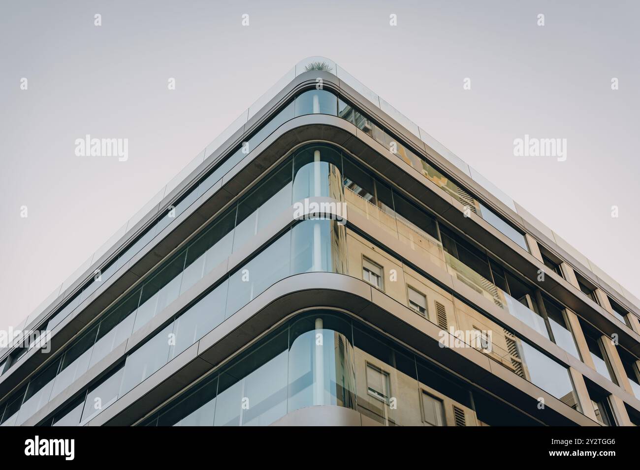Glass-walled office building with rounded edges, featuring contemporary ...
