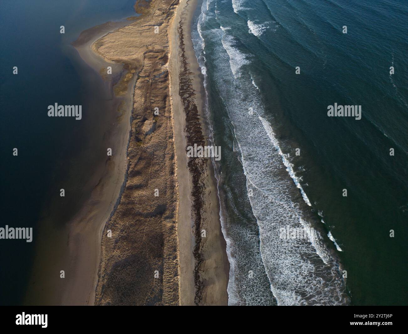 Aerial view of a sandy beach and ocean waves creating a beautiful ...