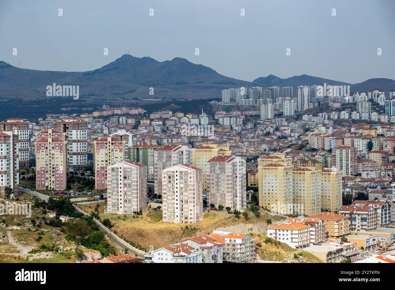 A sprawling cityscape with high-rise apartment buildings, nestled ...