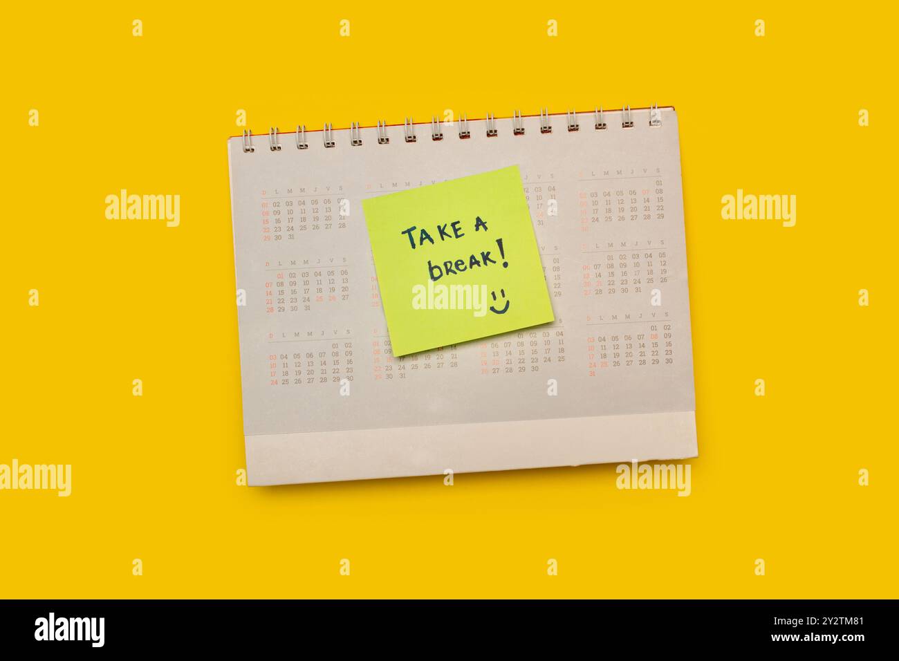 A calendar with a sticky paper with take a break phrase and a smiley ...