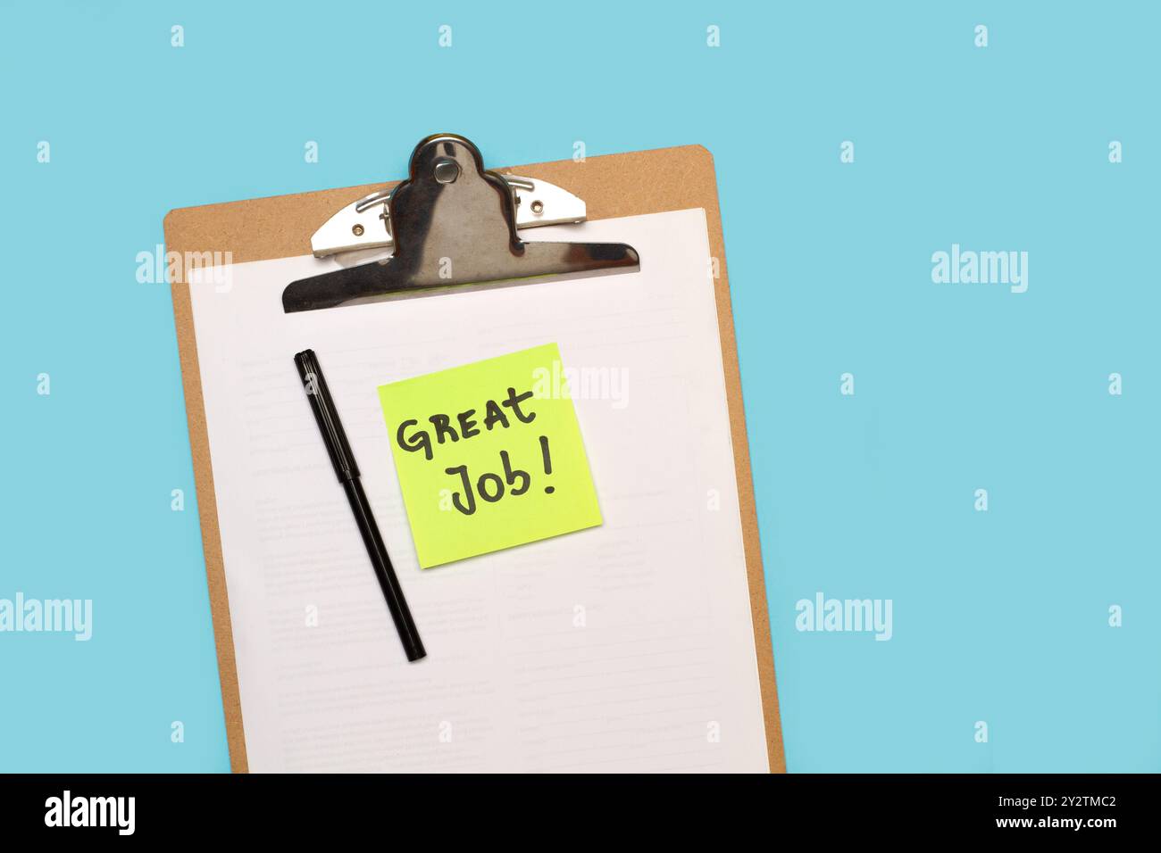 Great job handwritten on a sticky paper on a clipboard table with white ...