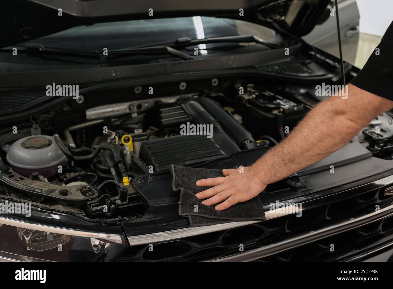 Man wiping auto engine with rag at car wash, closeup Stock Photo - Alamy