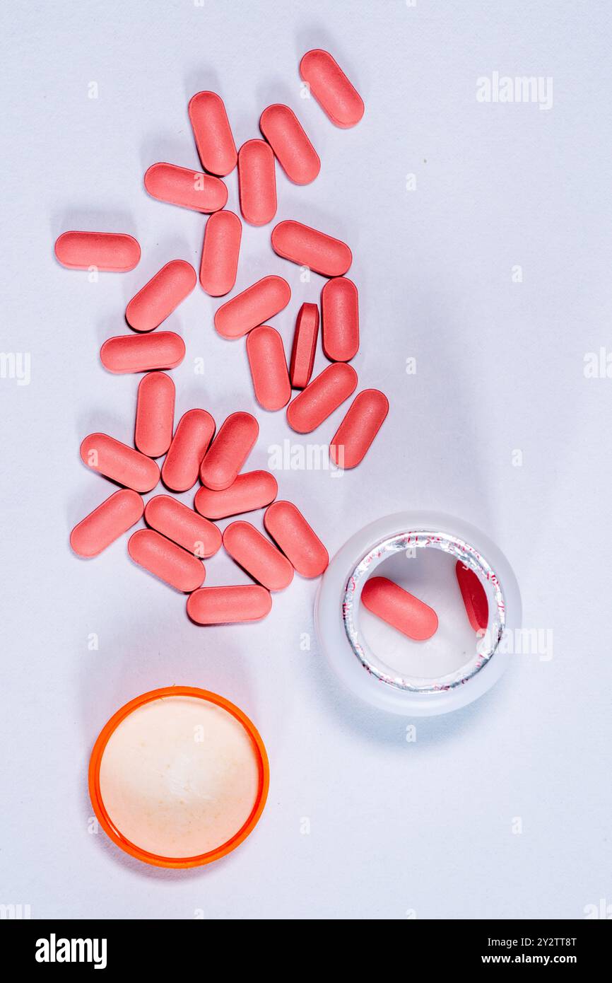 Open Pill Bottle with Scattered Red Tablets on White Background Stock ...