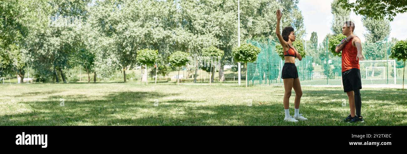 Two friends push each other during an outdoor workout, celebrating ...