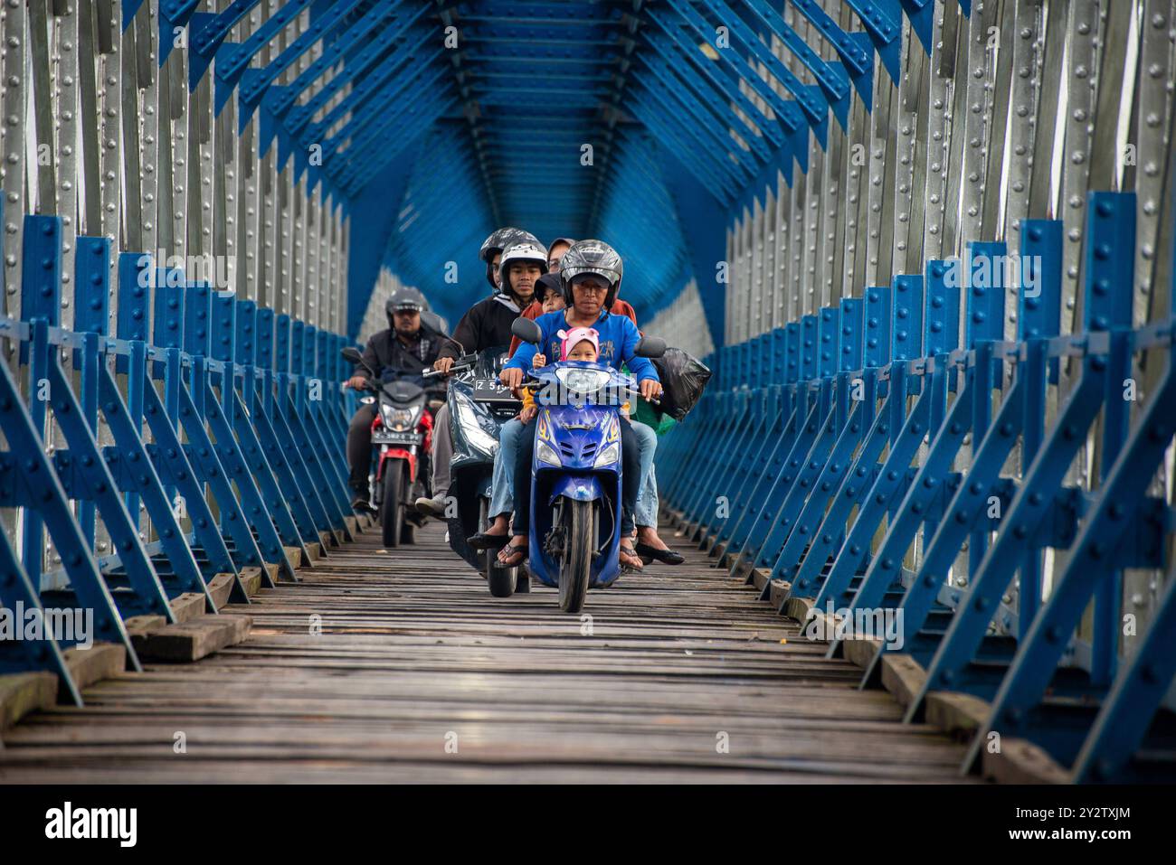 OLD RAILROAD BRIDGE IN WEST JAVA Motorcyclists cross the Cirahong ...