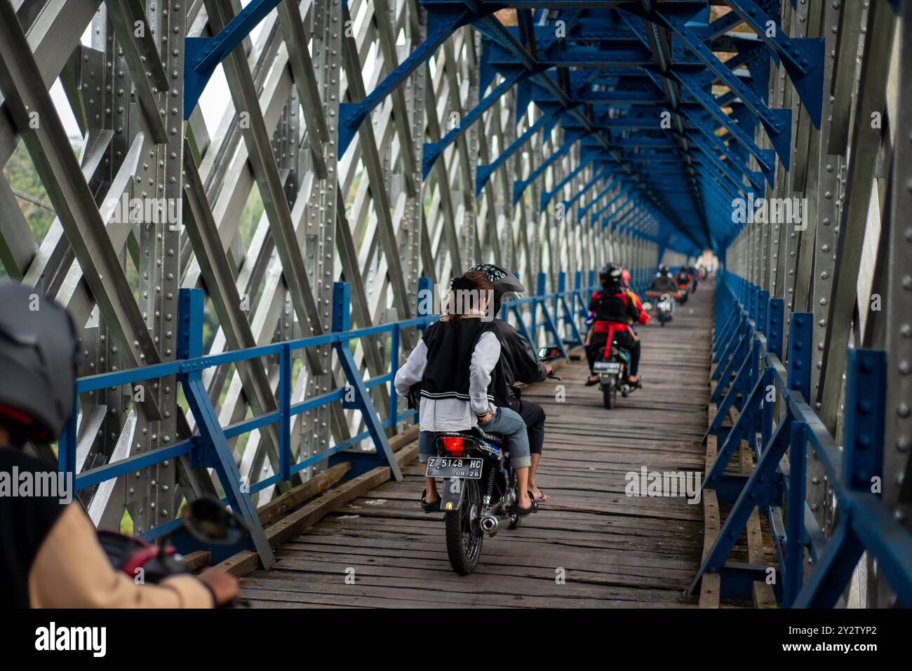 OLD RAILROAD BRIDGE IN WEST JAVA Motorcyclists cross the Cirahong ...