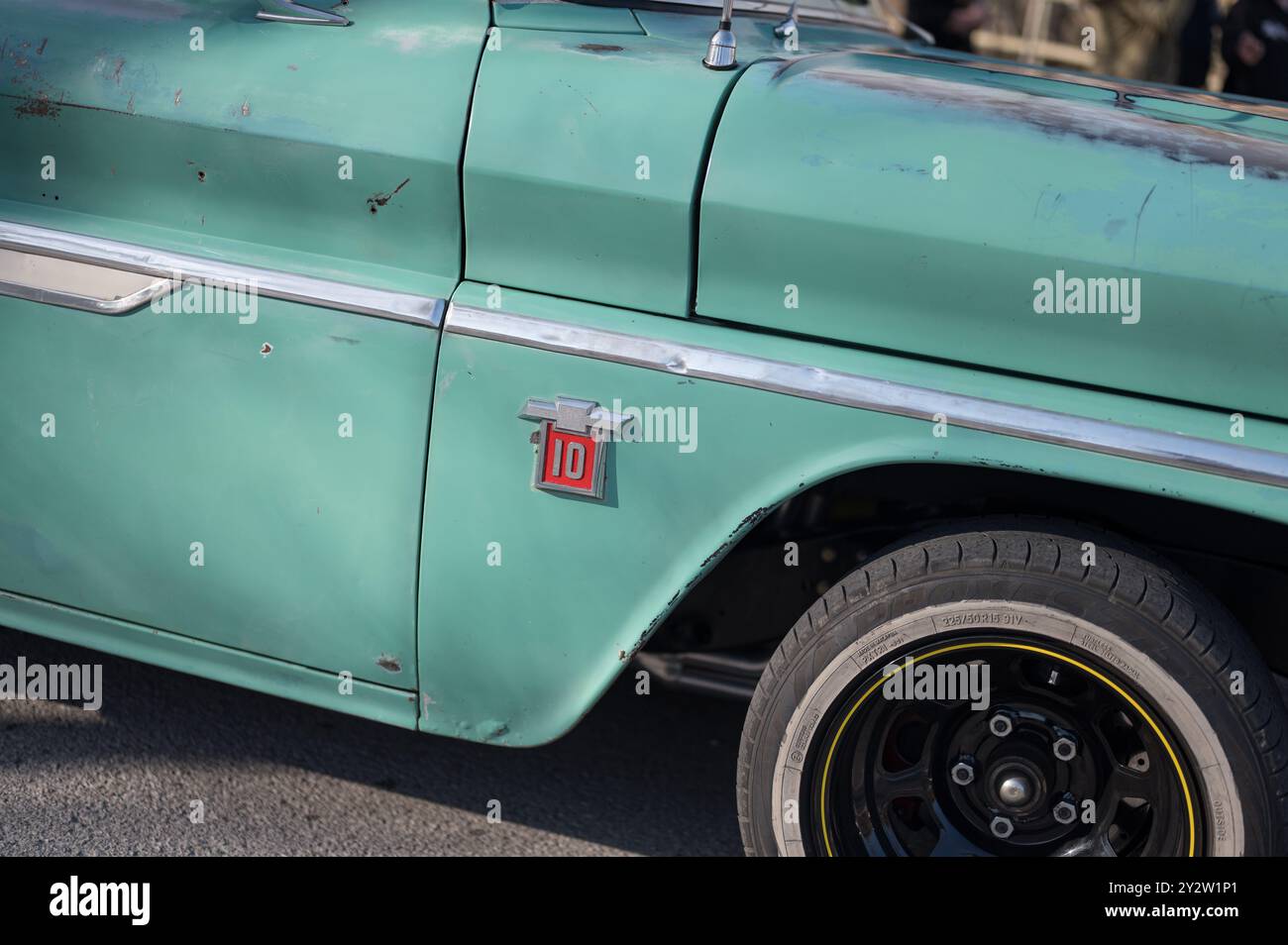 Detail closeup of the logo of an old American green Chevrolet C-10 ...
