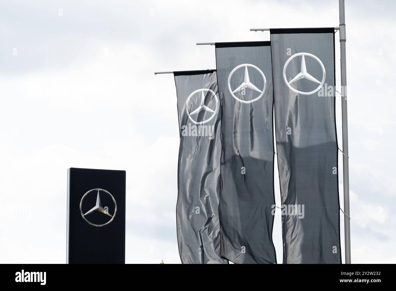 the Daimler Mercedes Benz logo on flags fluttering in the wind Stock ...