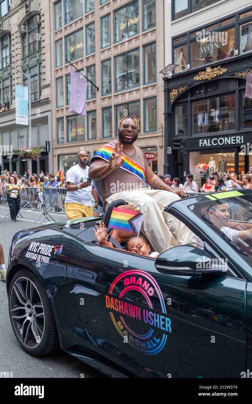 Grand Marshal Dashawn Usher at NYC Pride Parade, waving from a car with ...