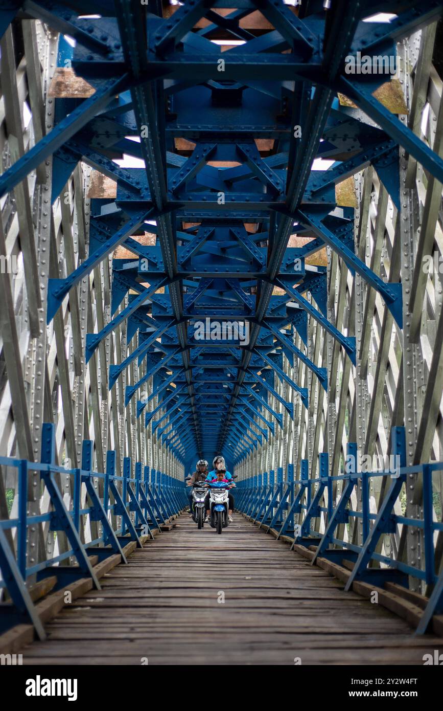 OLD RAILROAD BRIDGE IN WEST JAVA Motorcyclists cross the Cirahong ...