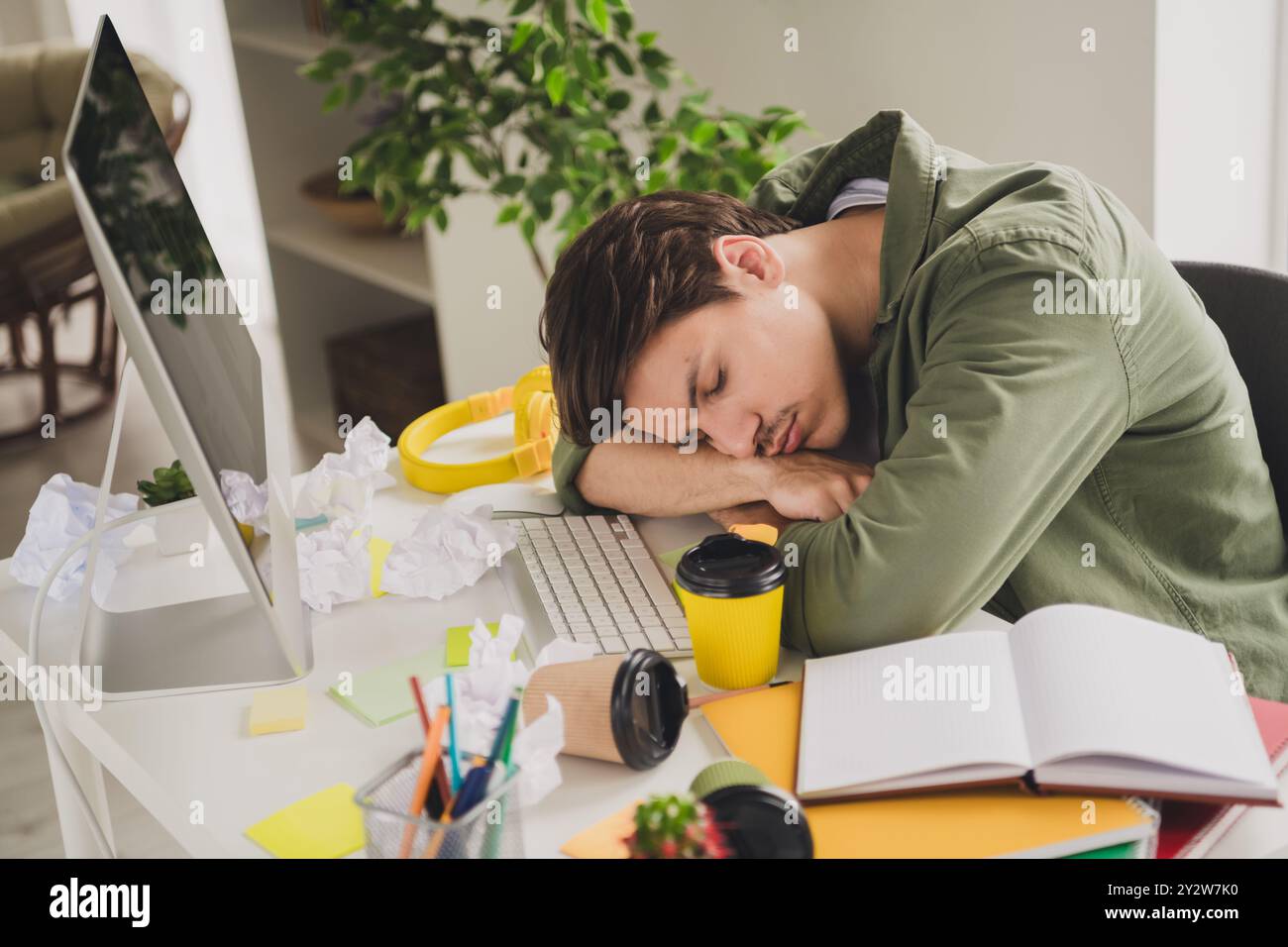Photo of bored sleepy man lying table hard work workstation workspace ...