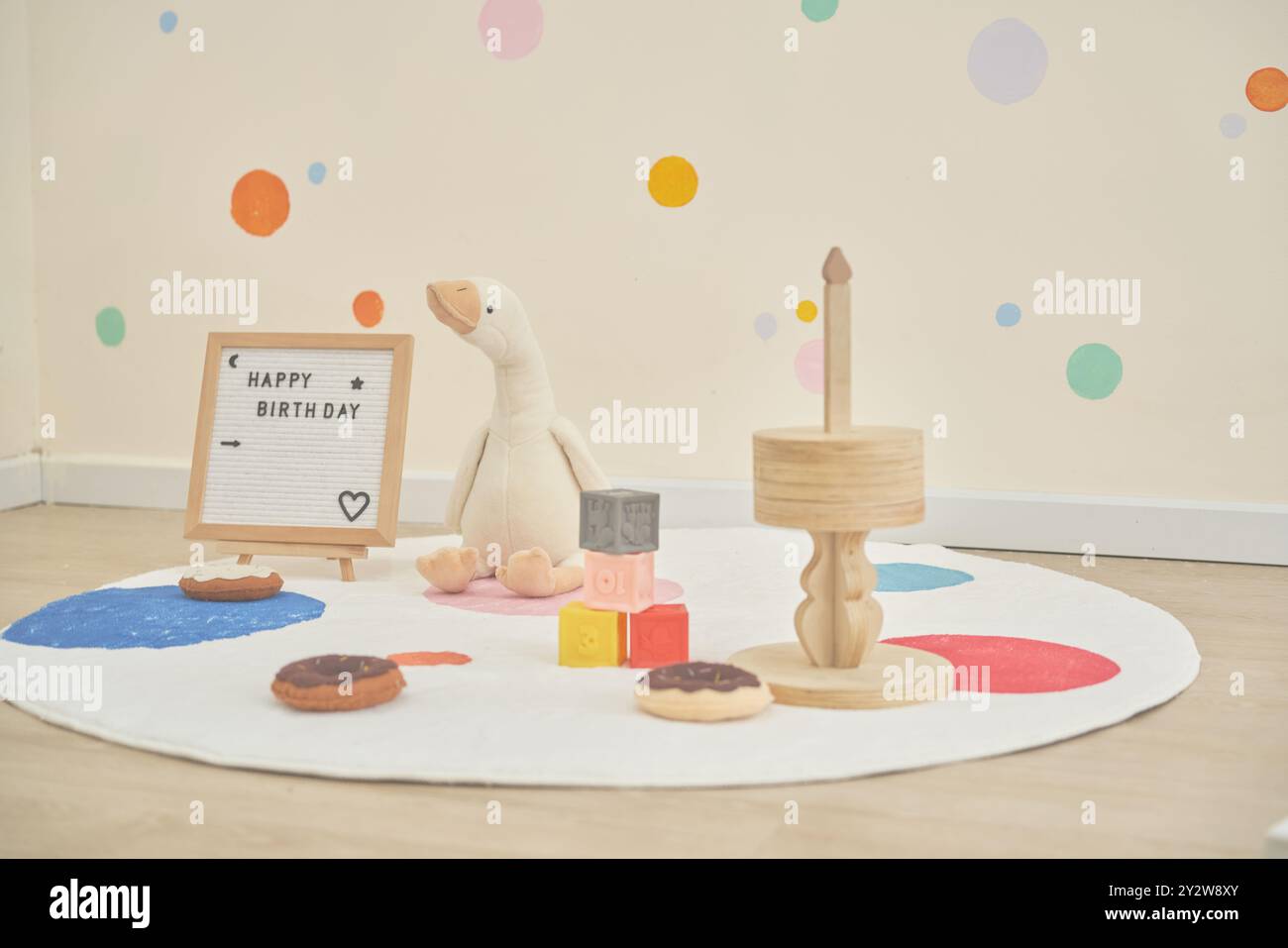 A cute birthday setup with a stuffed duck, a letter board reading ...