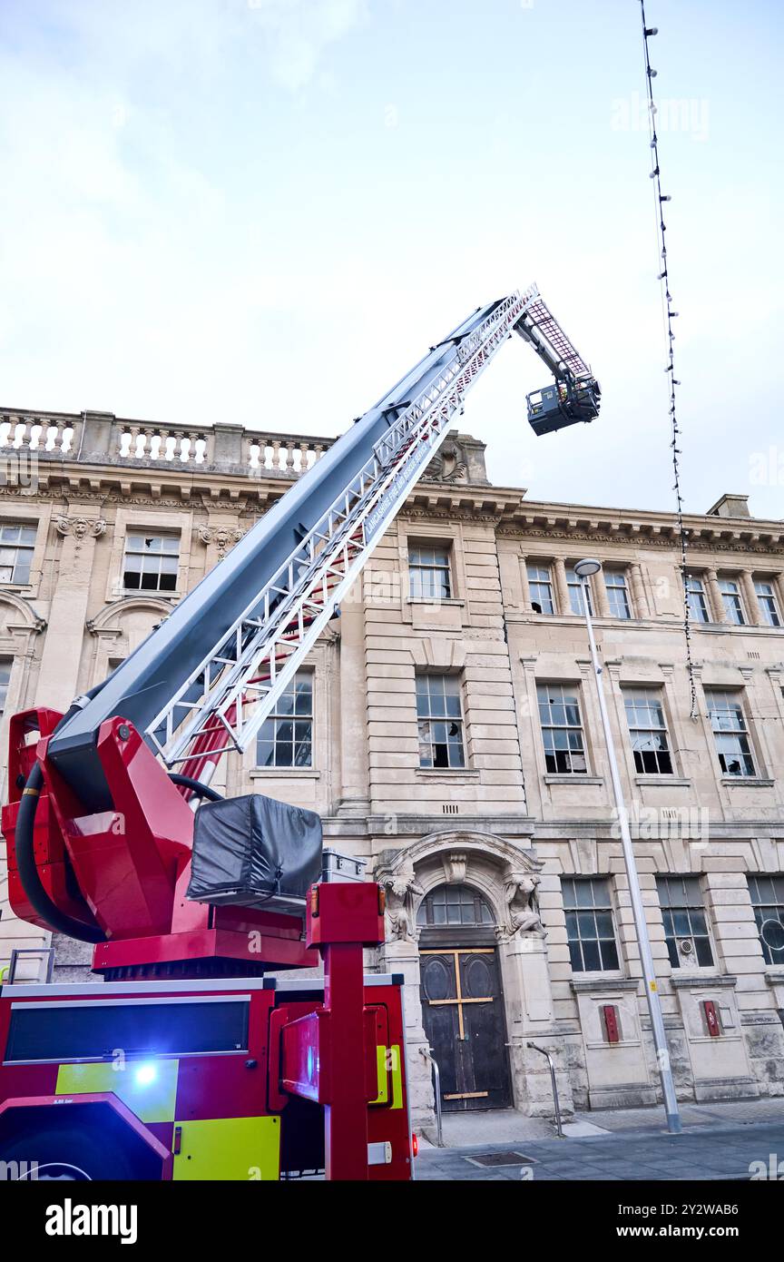 Fire Brigade aerial ladder checks out the roof of the former centrel ...