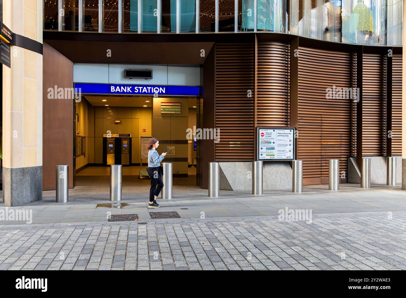 A woman walking past the Walbrook entrance to Bank underground station ...