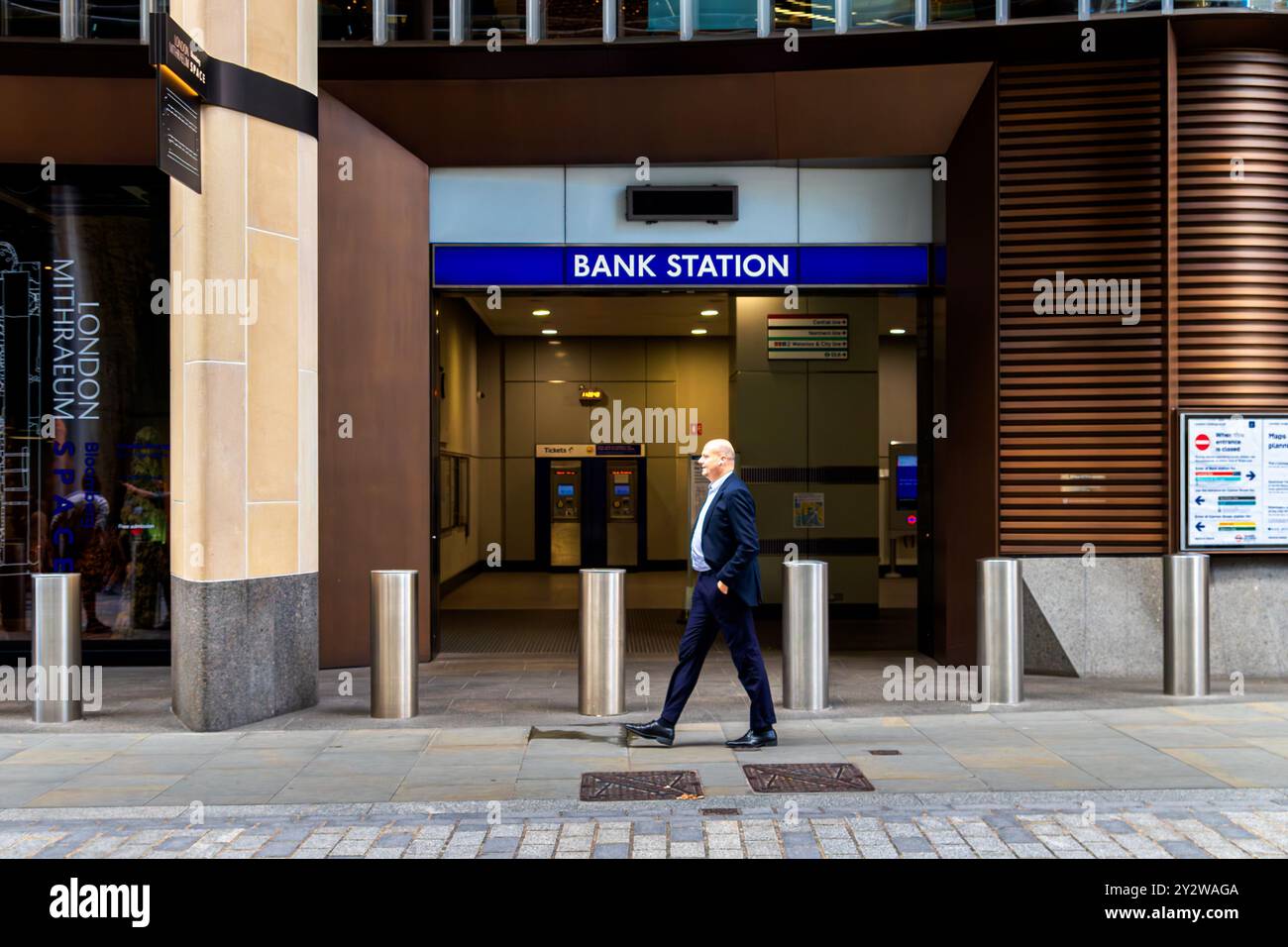 A man in a suit walking past the Walbrook entrance to Bank station ...