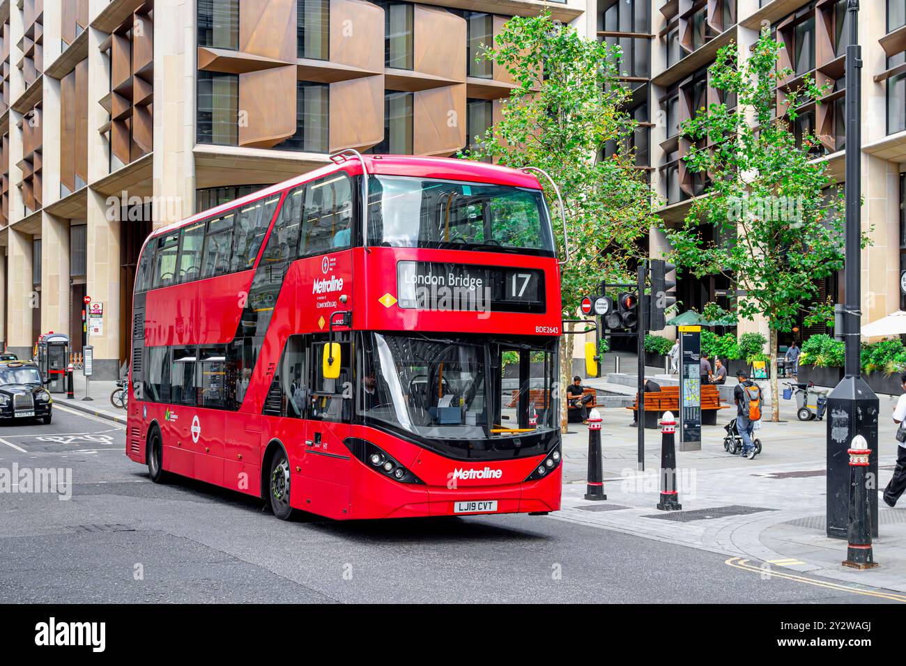 A No 17 red London double decker bus makes it's way along Cannon Street ...