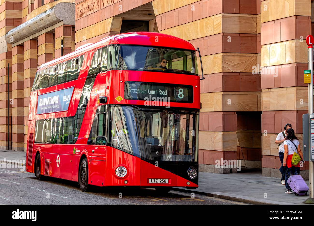 A No 8 red London double decker bus makes it's way along Poultry in The ...