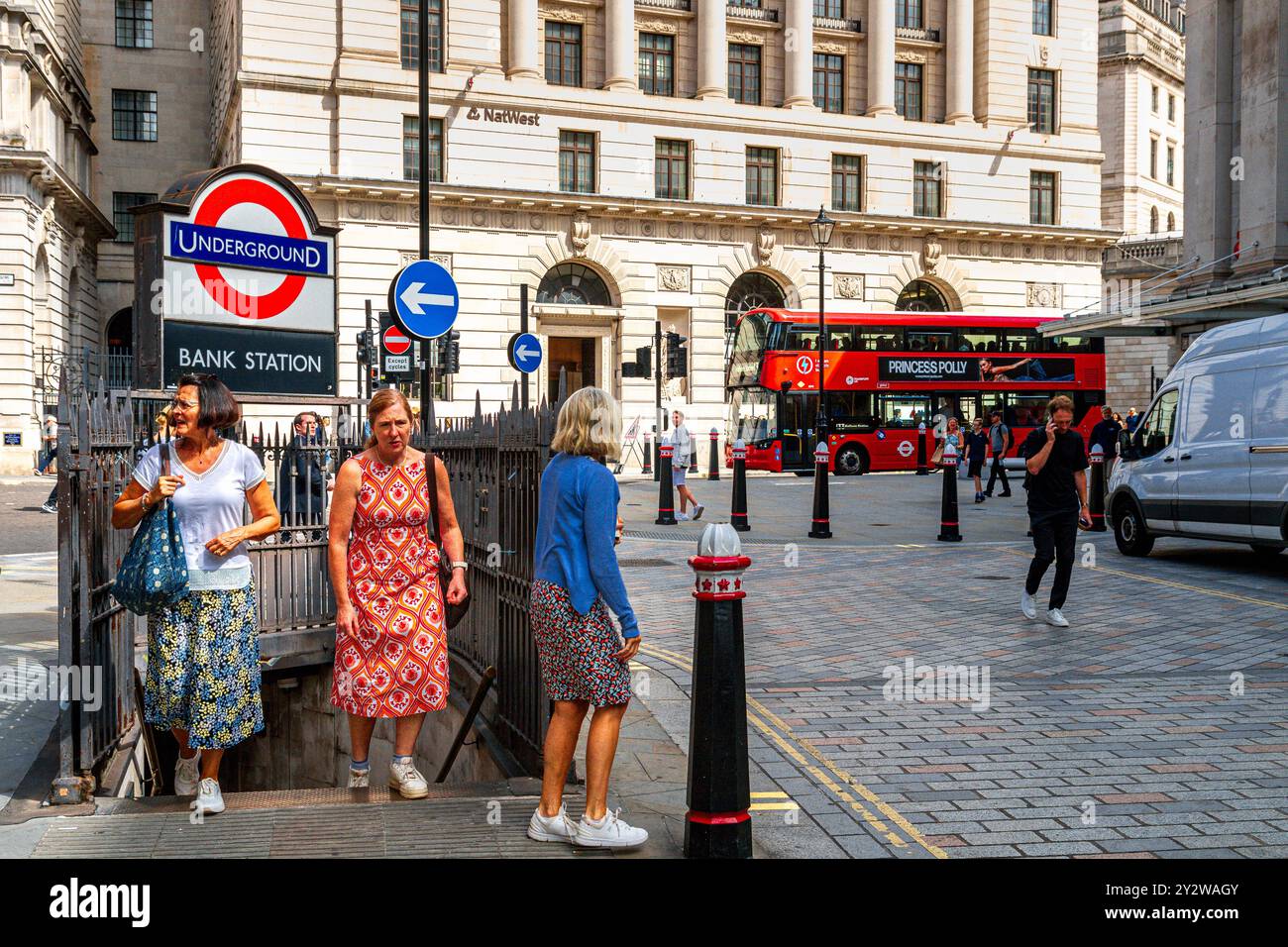 Three women exiting from The Queen Victoria Street entrance to Bank ...