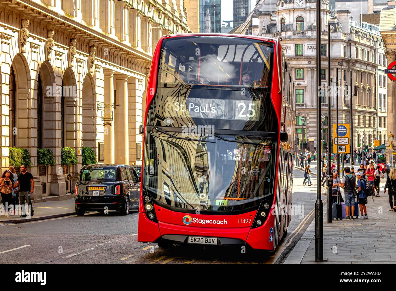 A No 25 red London double decker bus makes it's way along Poultry in ...