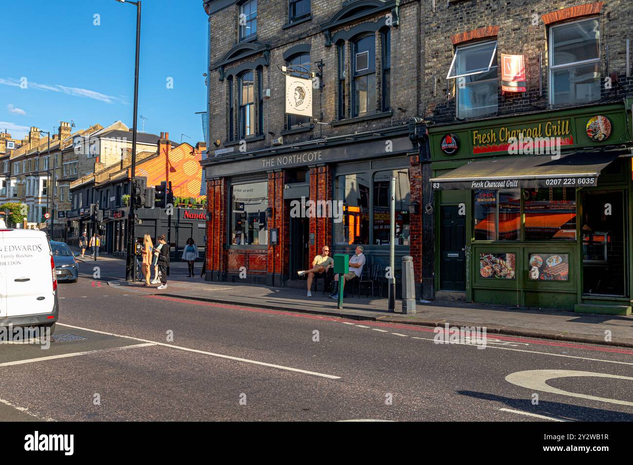 Two people sitting outside The Northcote ,a pub in Clapham Junction on ...